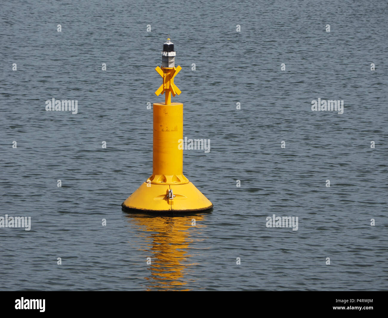 yellow buoy floating in the sea waves Stock Photo - Alamy