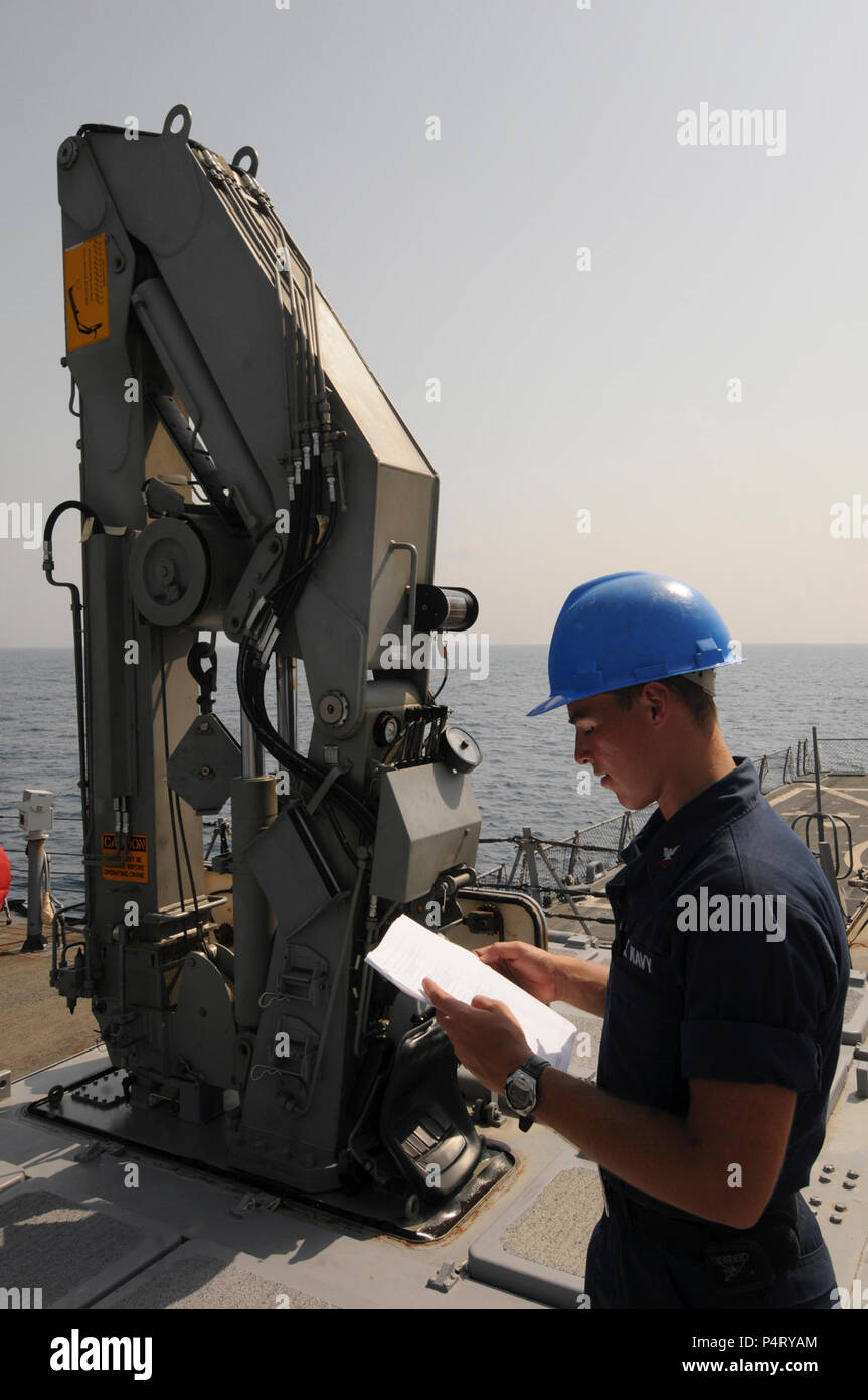 U.S. Navy Gunner?s Mate 2nd Class Travis Kaizen performs a maintenance ...