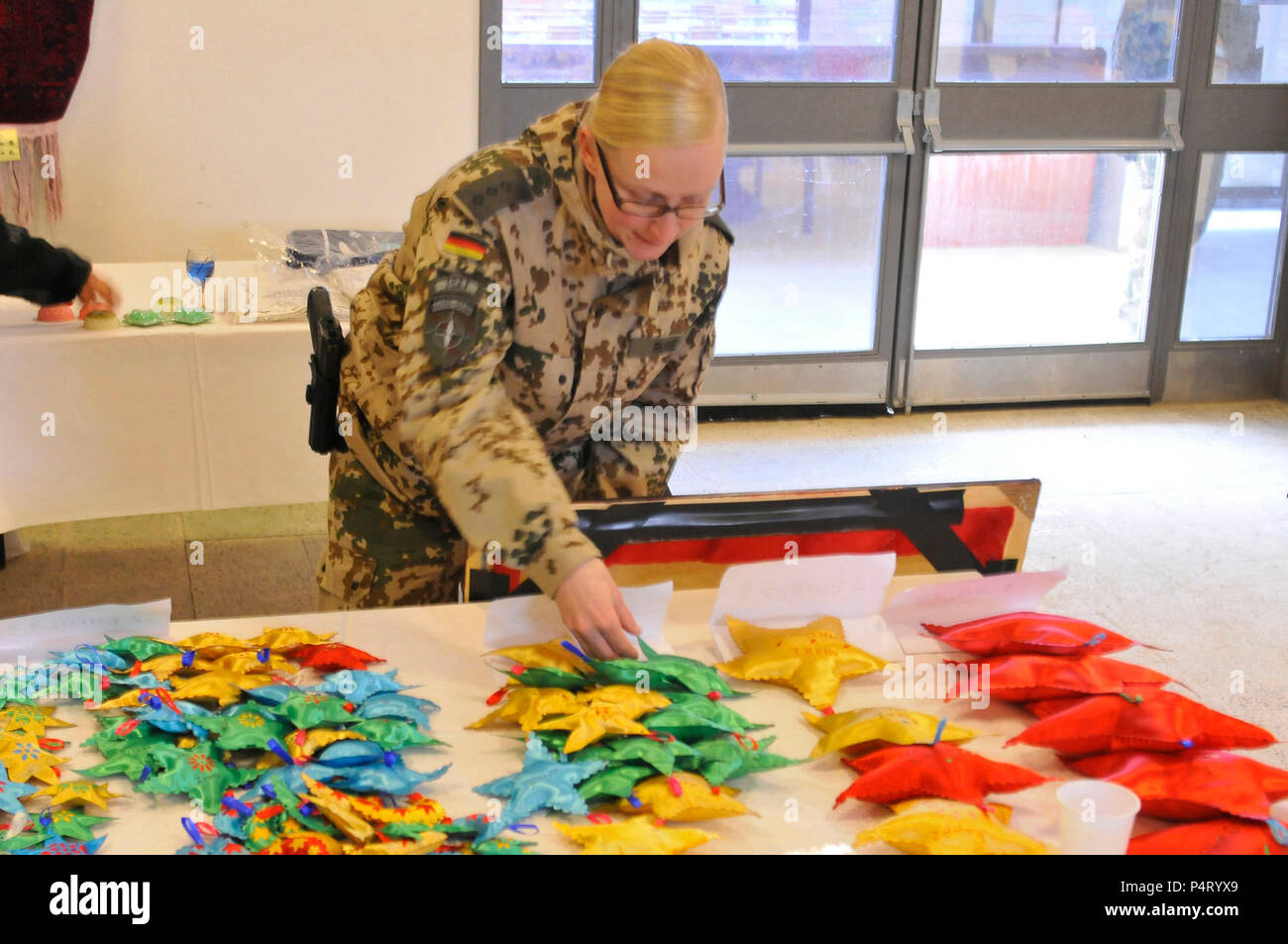 German Capt. Jennifer Ruge looks at the goods offered at the Afghan ...