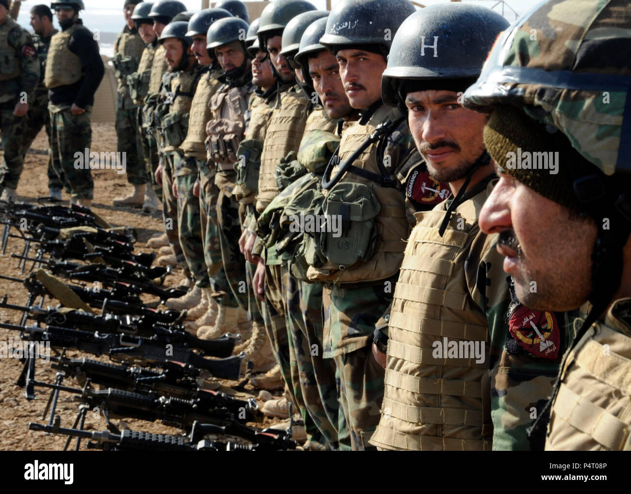Soldiers from the 8th Commando Kandak listen to a safety brief before a ...