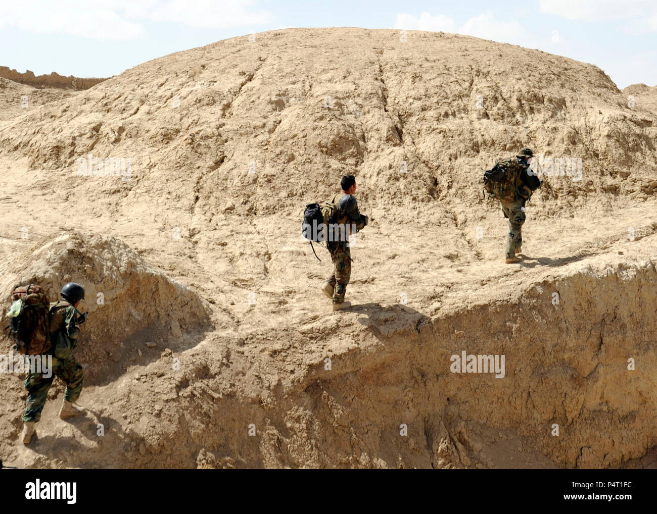 Soldiers from the 8th Commando Kandak through a river valley near ...