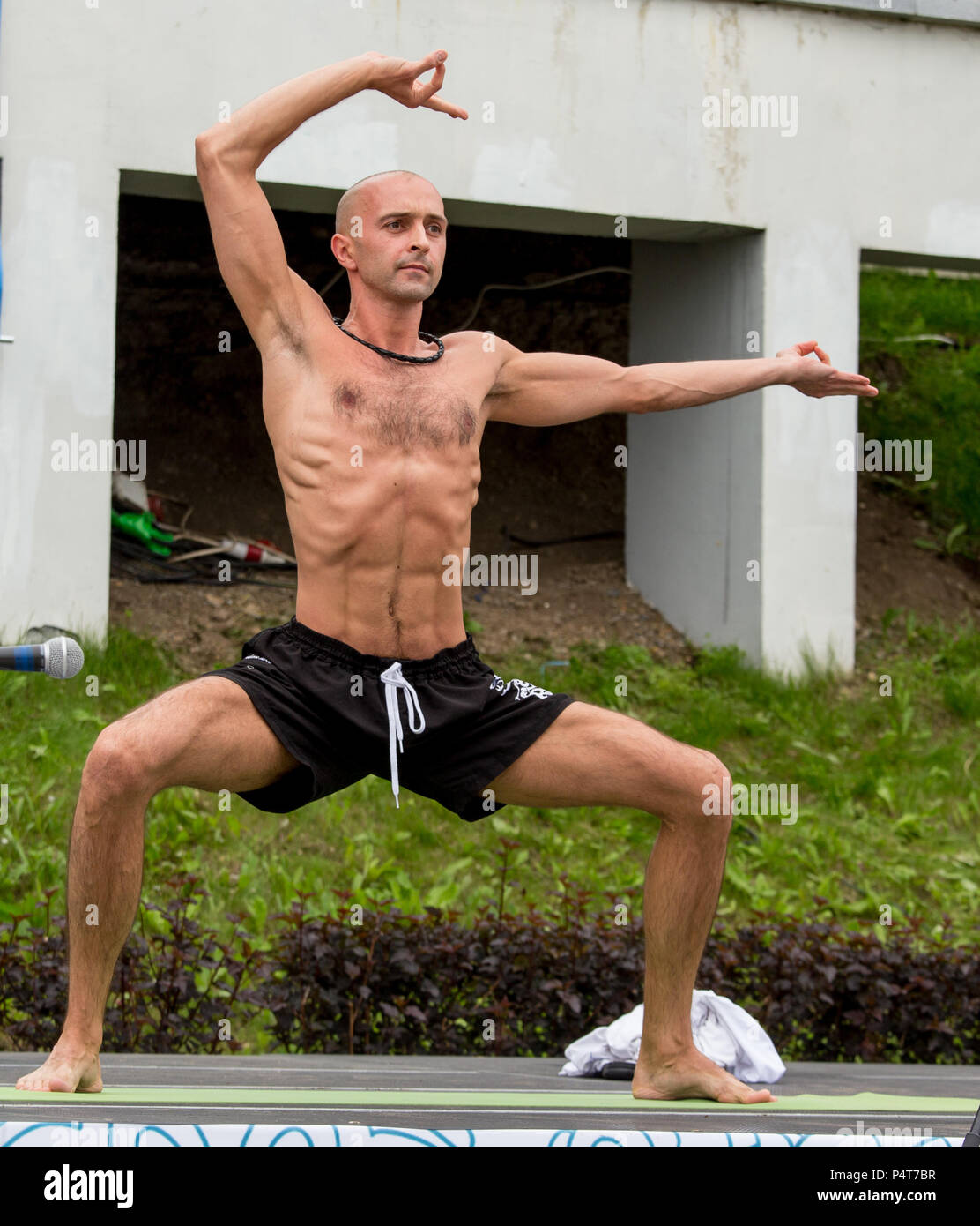 Russia, Vladivostok, 06/18/2016. Caucasian trainer presents yoga's ...