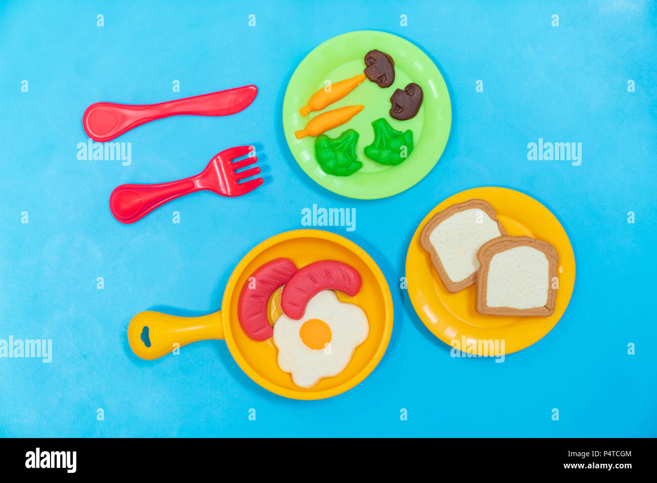 Breakfast model with egg sausage bread and salad on plastic blue table ...