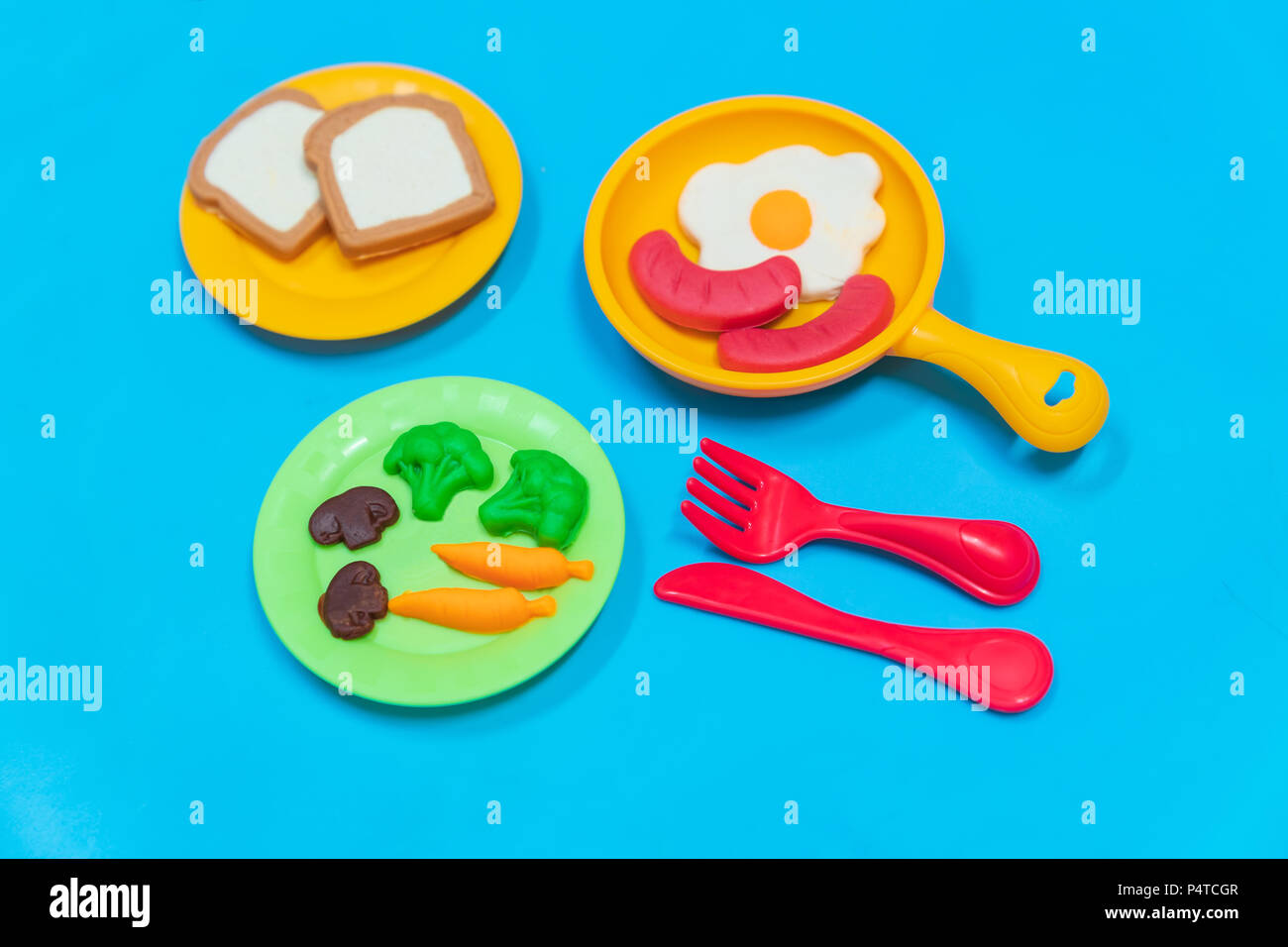 Breakfast model with egg sausage bread and salad on plastic blue table ...