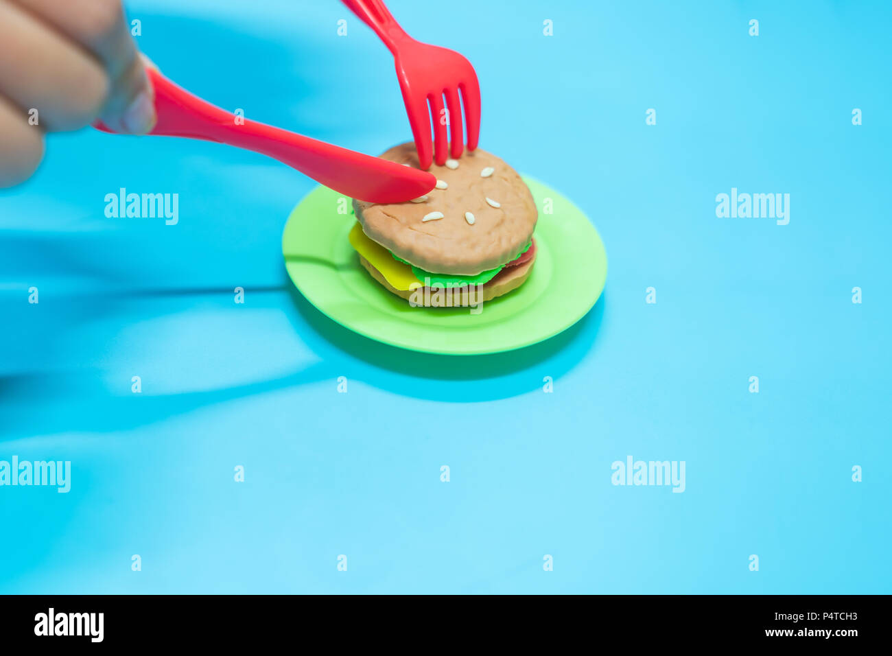 Fastfood model with hamburger chesse on plastic blue table background ...