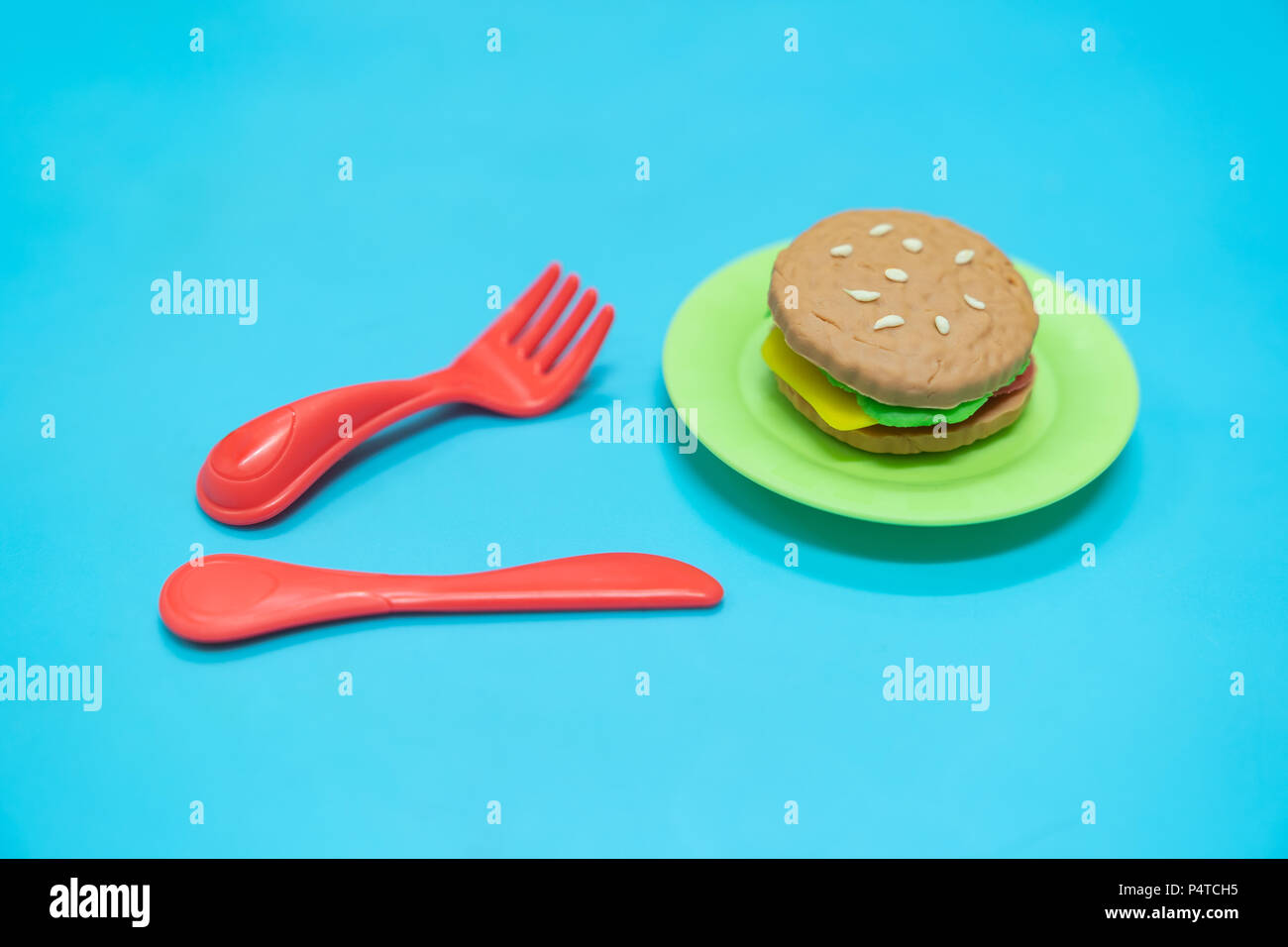 Fastfood model with hamburger chesse on plastic blue table background ...