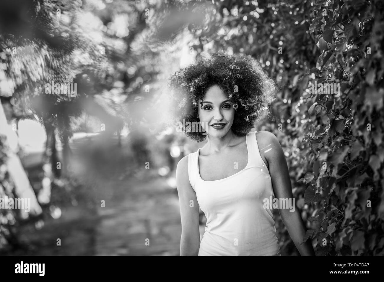 Young Black Woman With Afro Hairstyle Smiling In Urban Park Mixed Girl