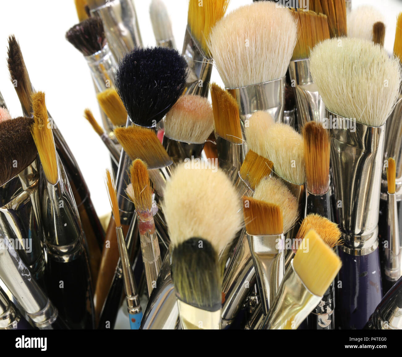 brushes of different shapes and sizes just used by a painter to paint a ...