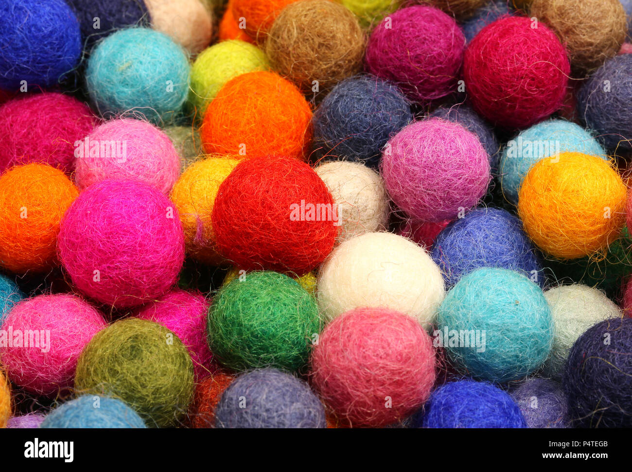 Many colored felt balls forming a background Stock Photo - Alamy