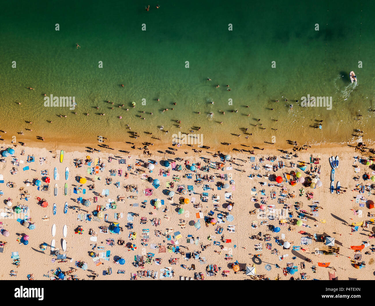 Aerial View From Flying Drone Of People Crowd Relaxing On Algarve Beach ...