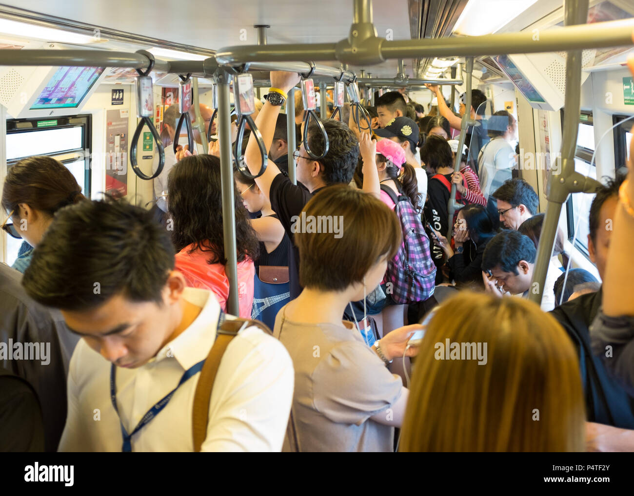 Crowd of passengers travelling in subway (BTS) train, Bangkok, Thailand ...
