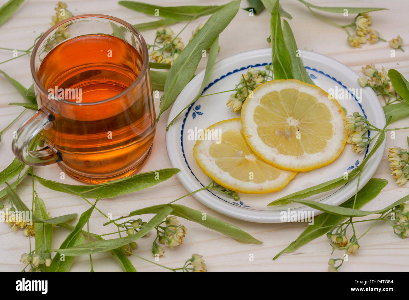 Linden tea in a glass cup blossoms and linden leaves Stock Photo - Alamy