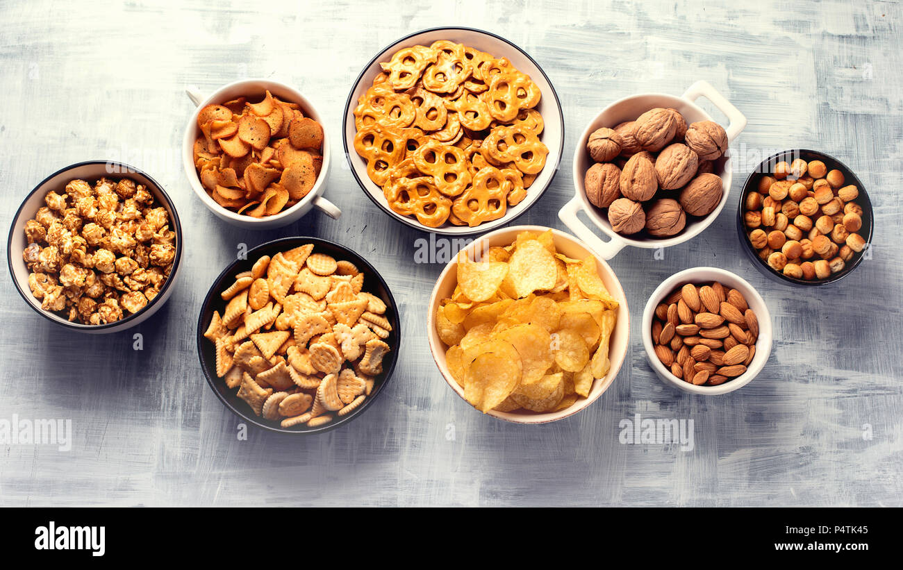 Different kids of snacks, chips, nuts and popcorn Stock Photo - Alamy