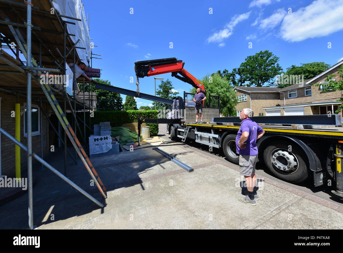 A crane lifting a girder into position Stock Photo - Alamy