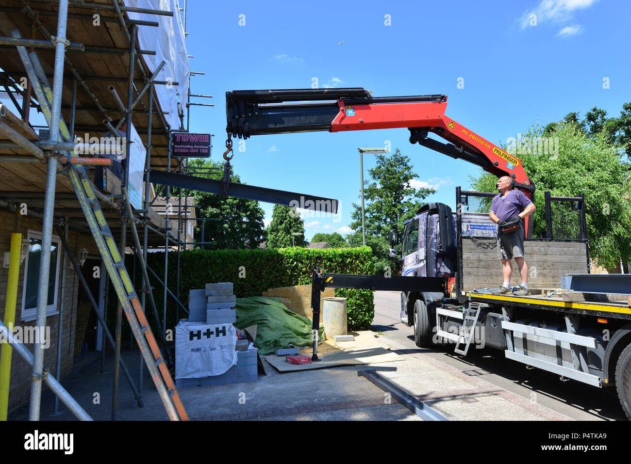 A crane lifting a girder into position Stock Photo - Alamy