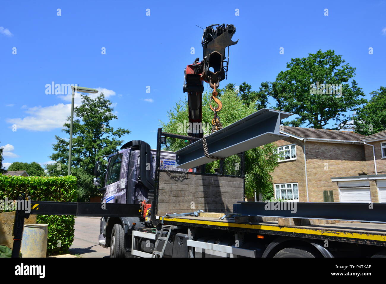A crane lifting a girder into position Stock Photo - Alamy