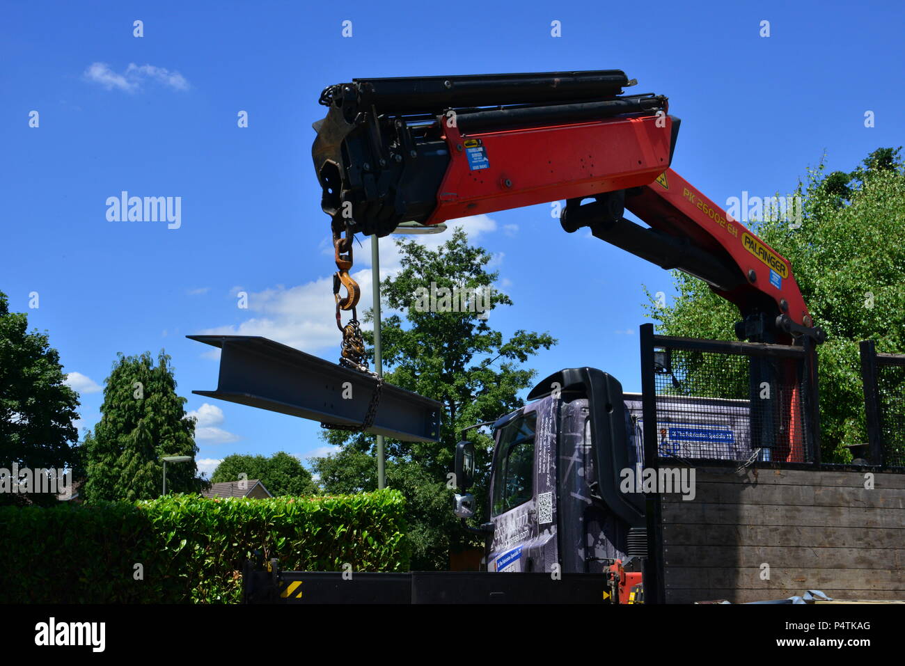 A crane lifting a girder into position Stock Photo - Alamy