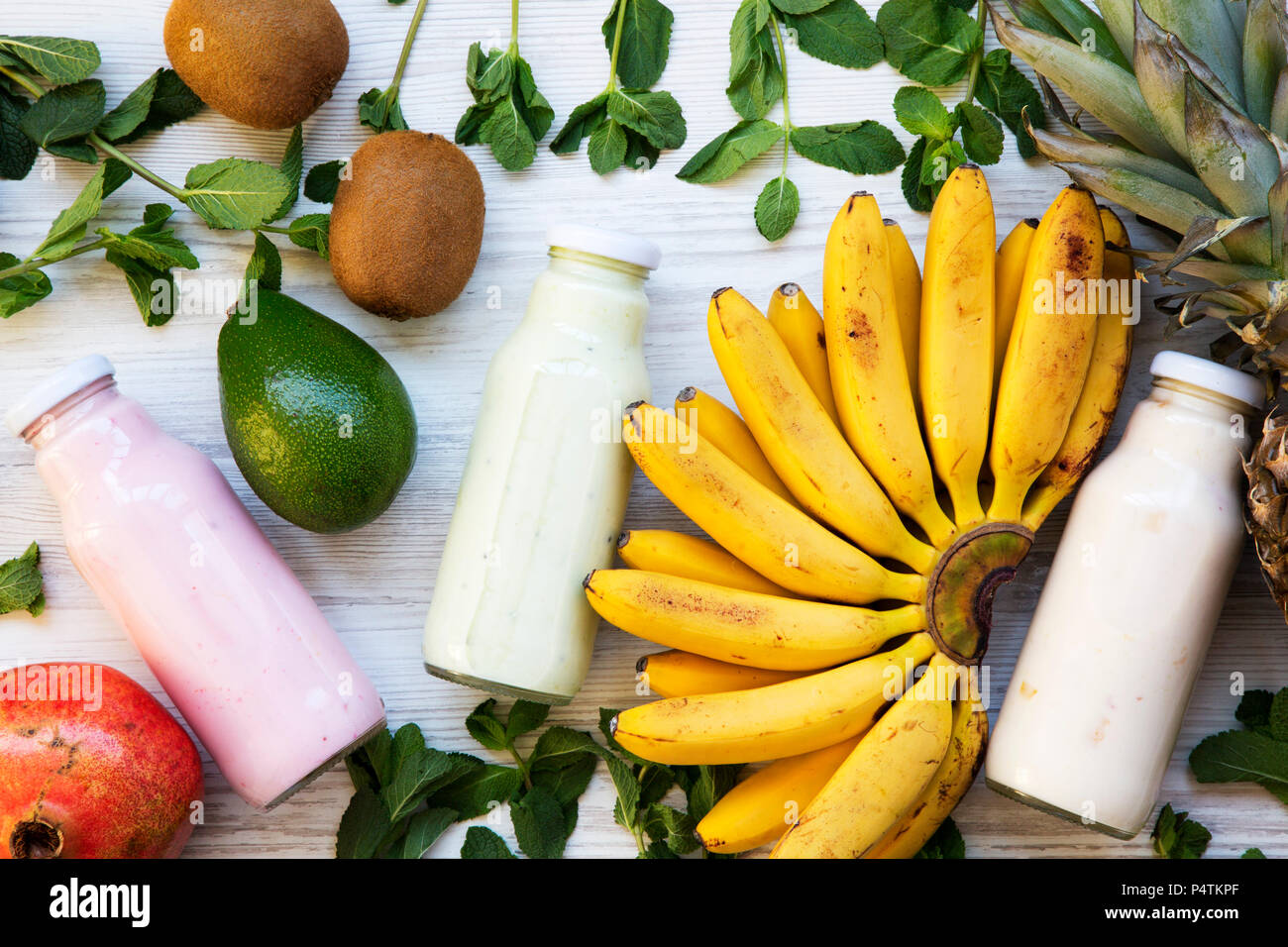 Fruit smoothies of different tastes in glass jars with ingredients on ...