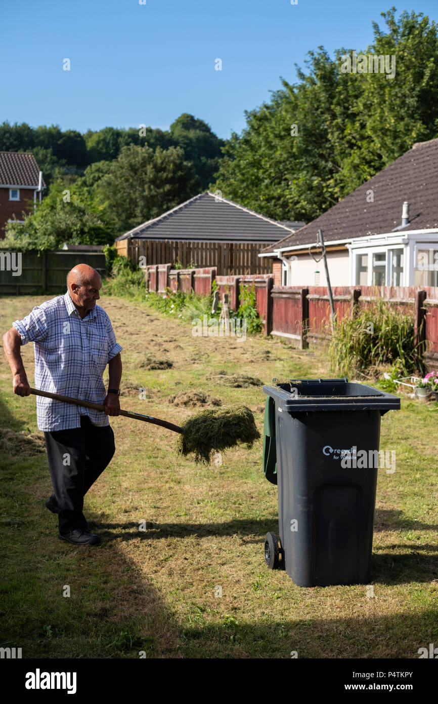 Male raking grass hi-res stock photography and images - Alamy