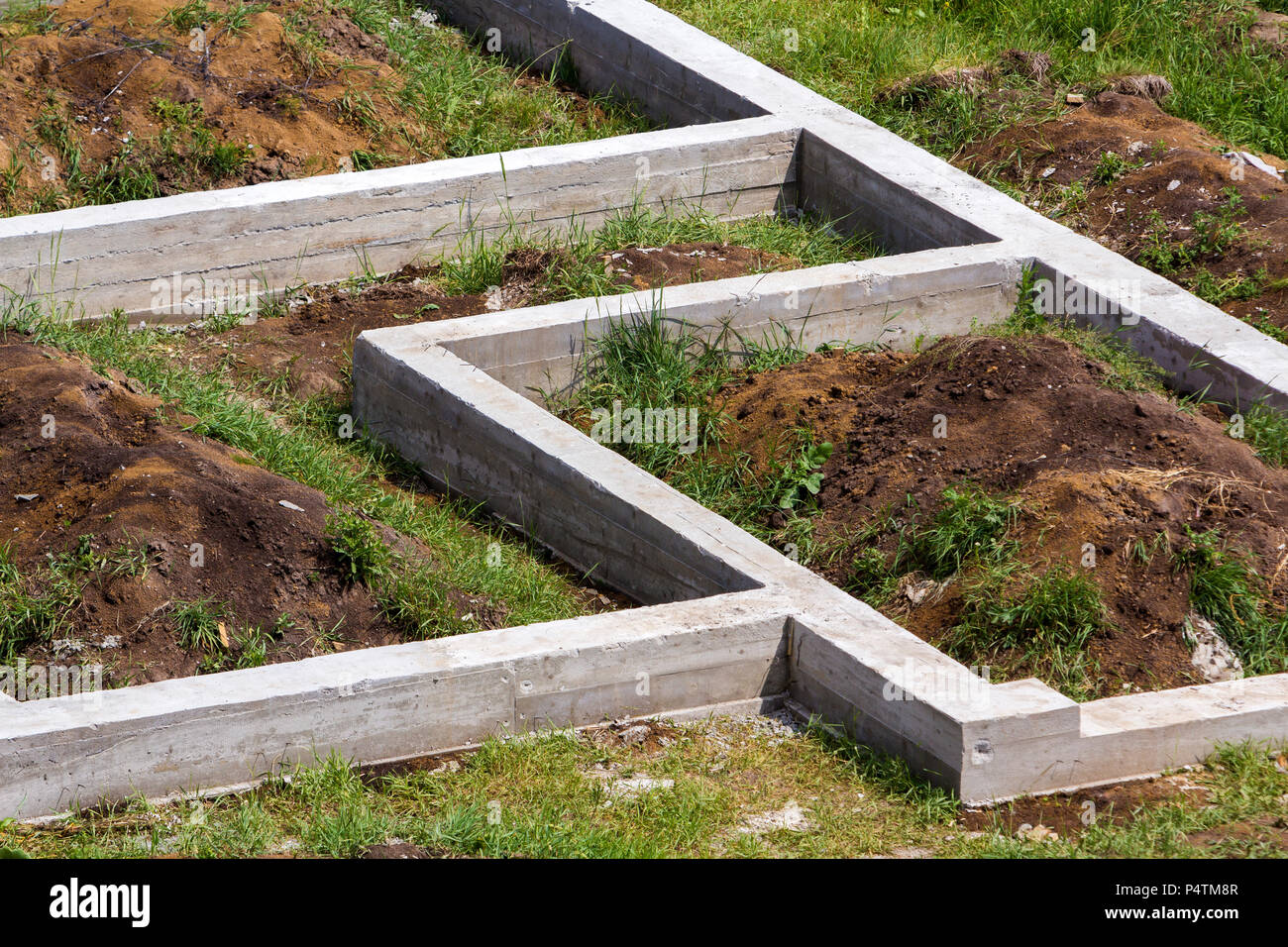 Building site in green field. Close-up detail of trenches dug in ground ...