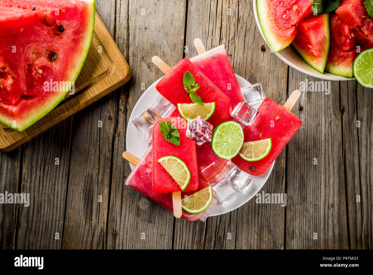 Sweet summer watermelon and lime popsicles with sliced watermelon and ...