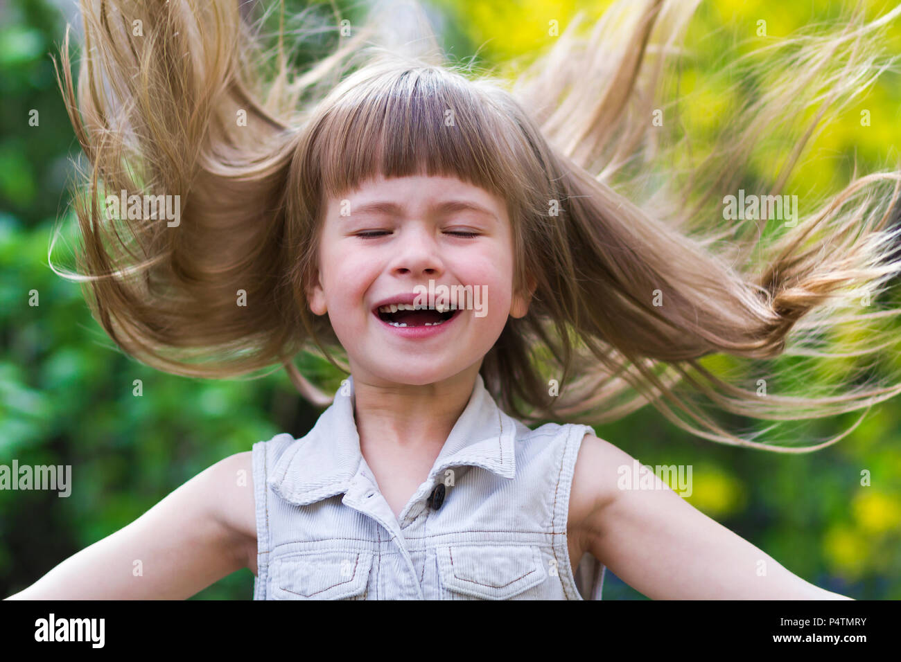 Portrait of a pretty little long-haired blond preschool girl in ...