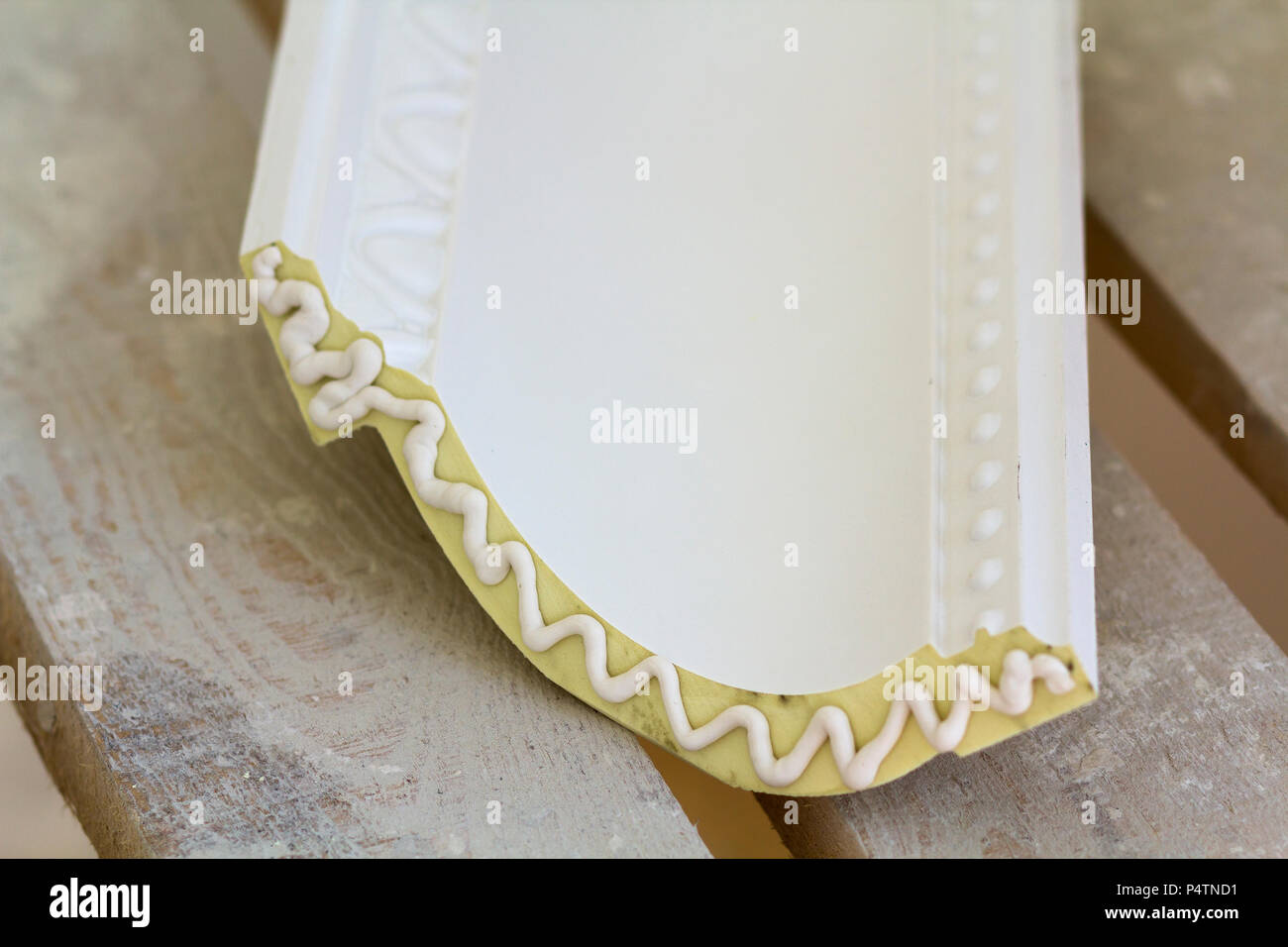 Close-up detail of decoration molding with glue adhesive before ...
