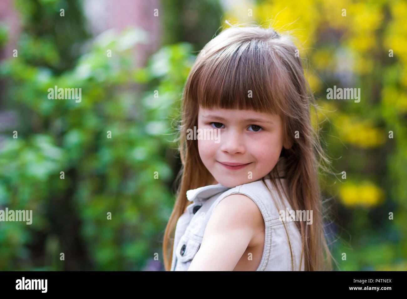 Portrait of a pretty little long-haired blond preschool girl in ...
