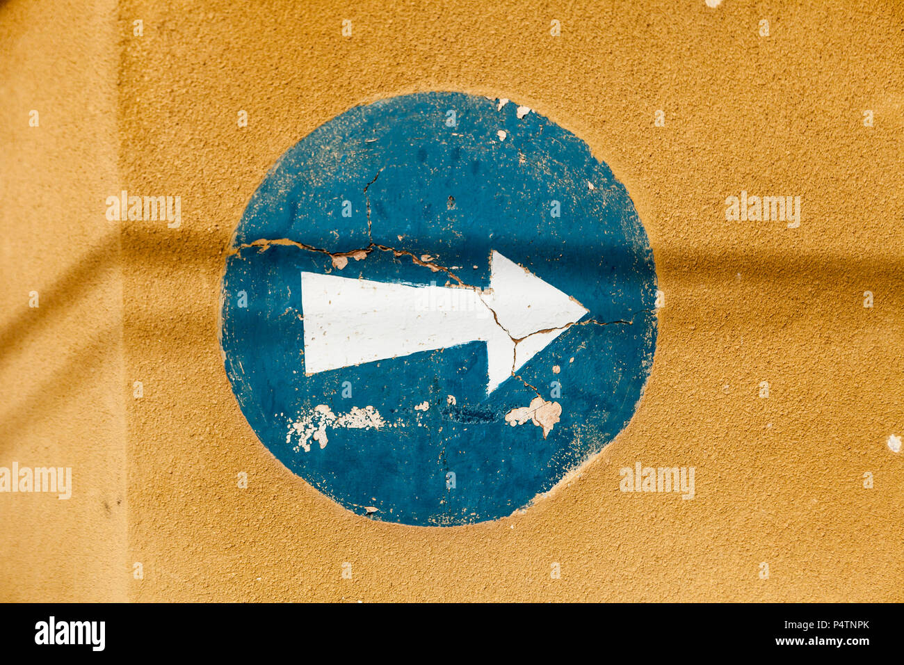 Painted blue and white one way sign on a street wall Stock Photo - Alamy