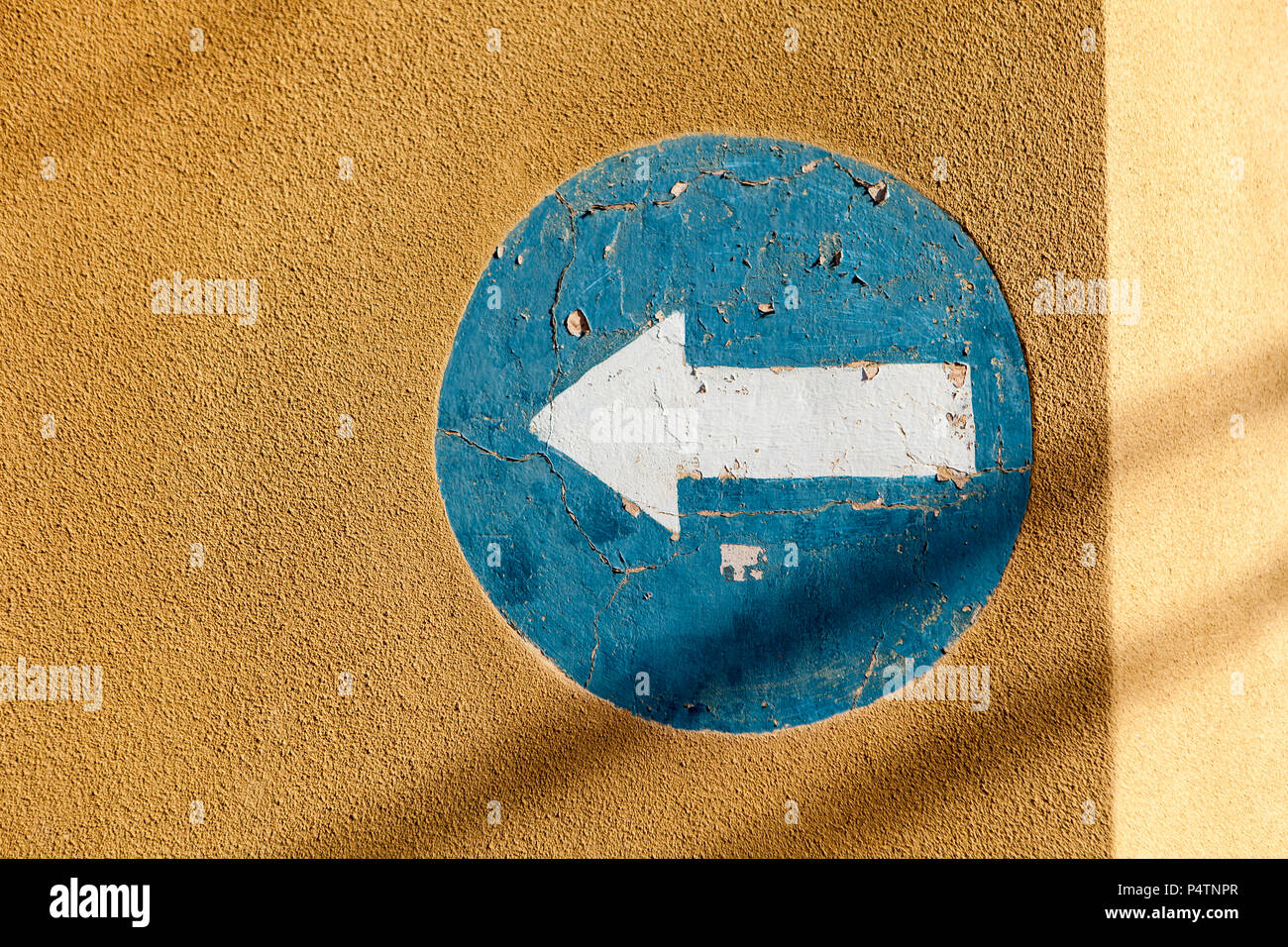 Painted blue and white one way sign on a street wall Stock Photo - Alamy