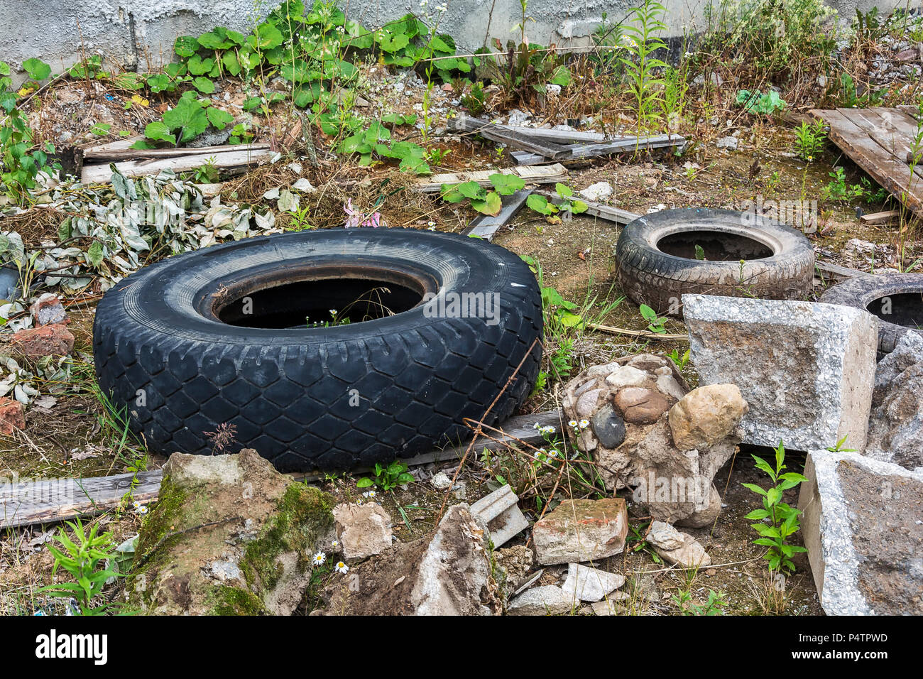 Environment and ecology. Tires from cars and construction debris dumped ...