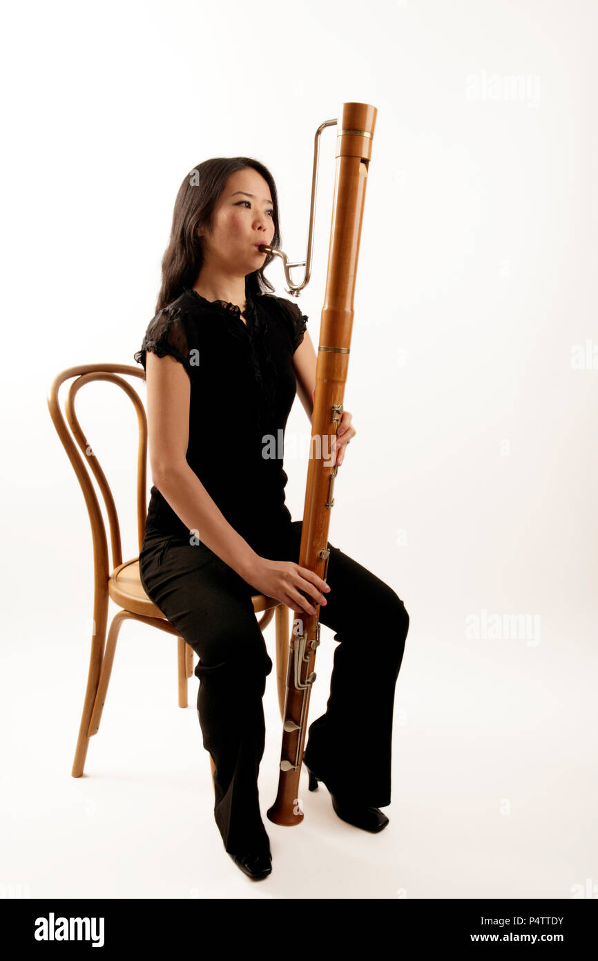Young woman playing the bass recorder Stock Photo - Alamy