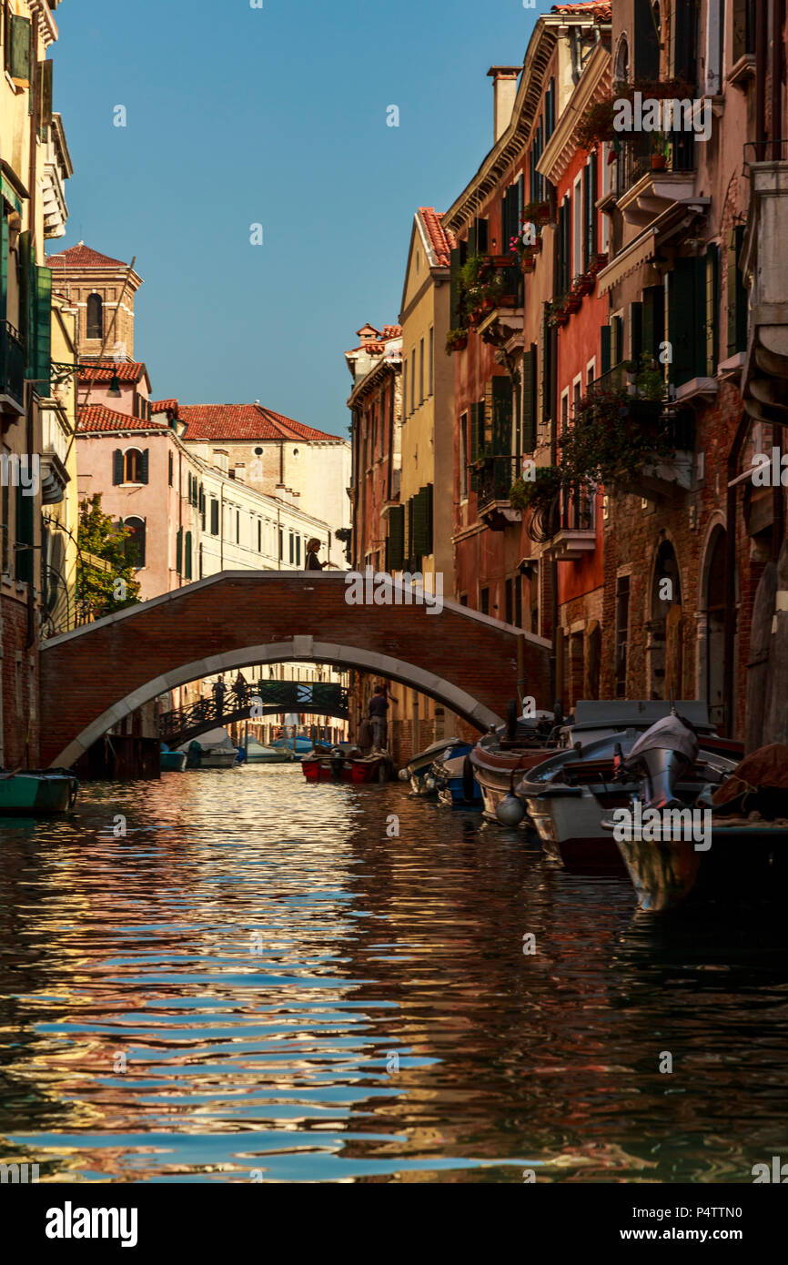 A Venice canal rich with morning sun, shadows, sky and reflections ...