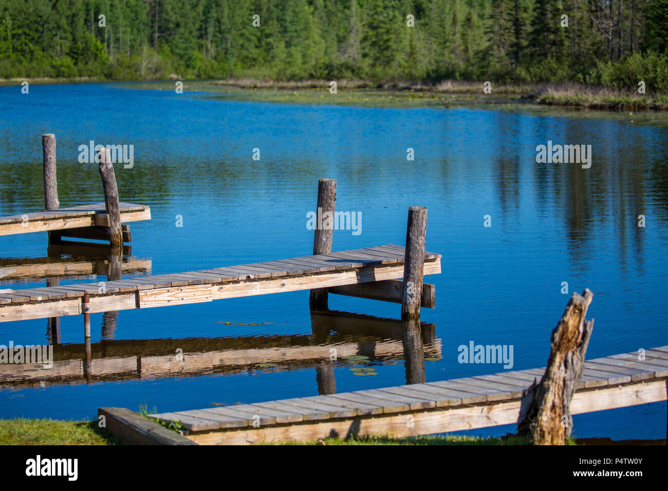 Three wooden docks on a lake in Wisconsin Stock Photo - Alamy