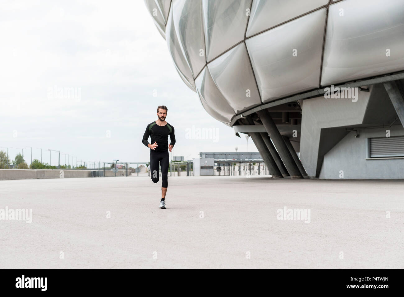 Man running at stadium Stock Photo - Alamy