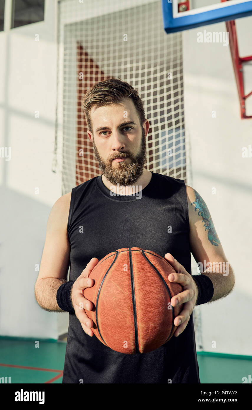 Man holding basketball, indoor Stock Photo - Alamy