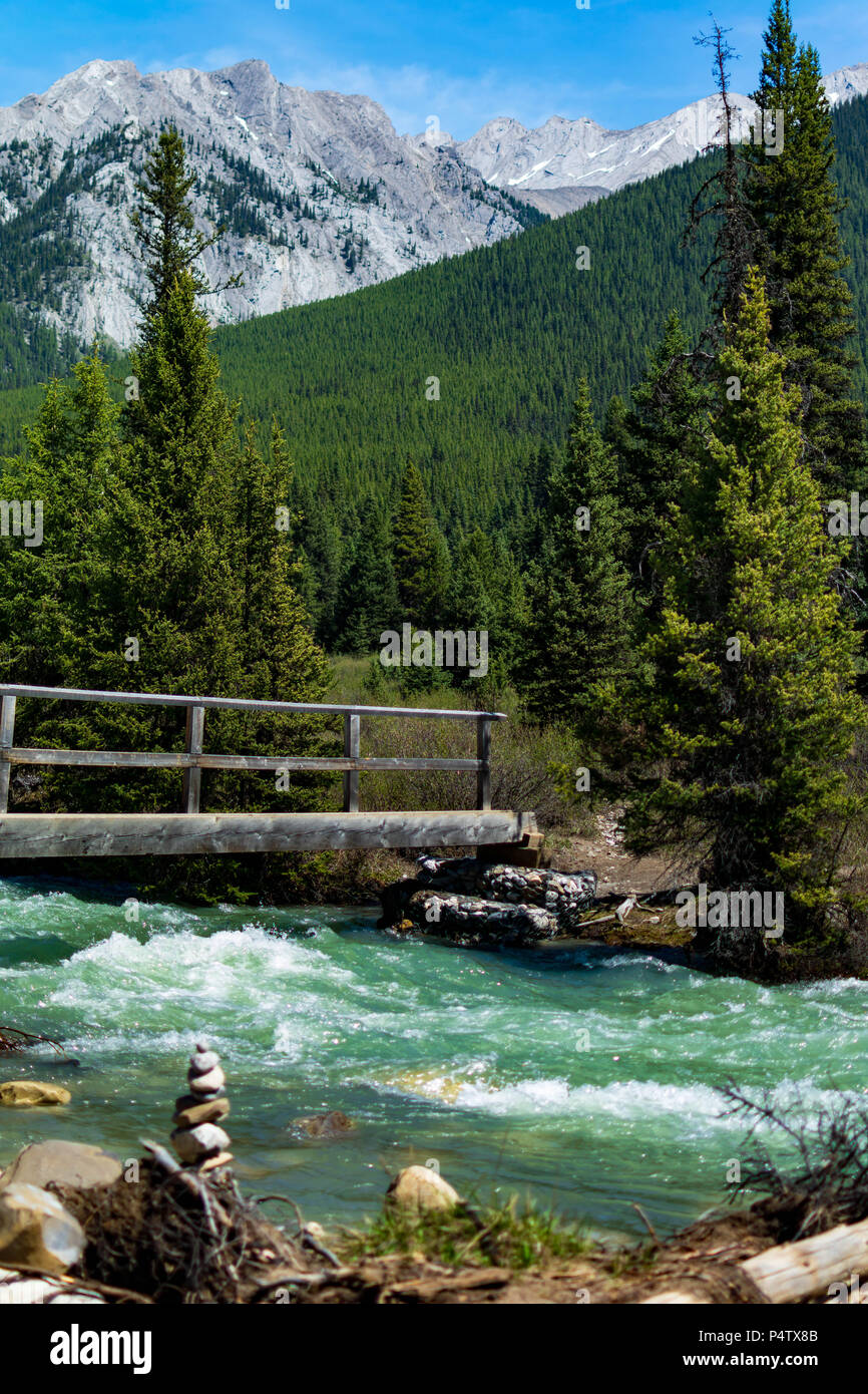 A bridge spanning a flowing river near the Ink Pots in Banff National ...
