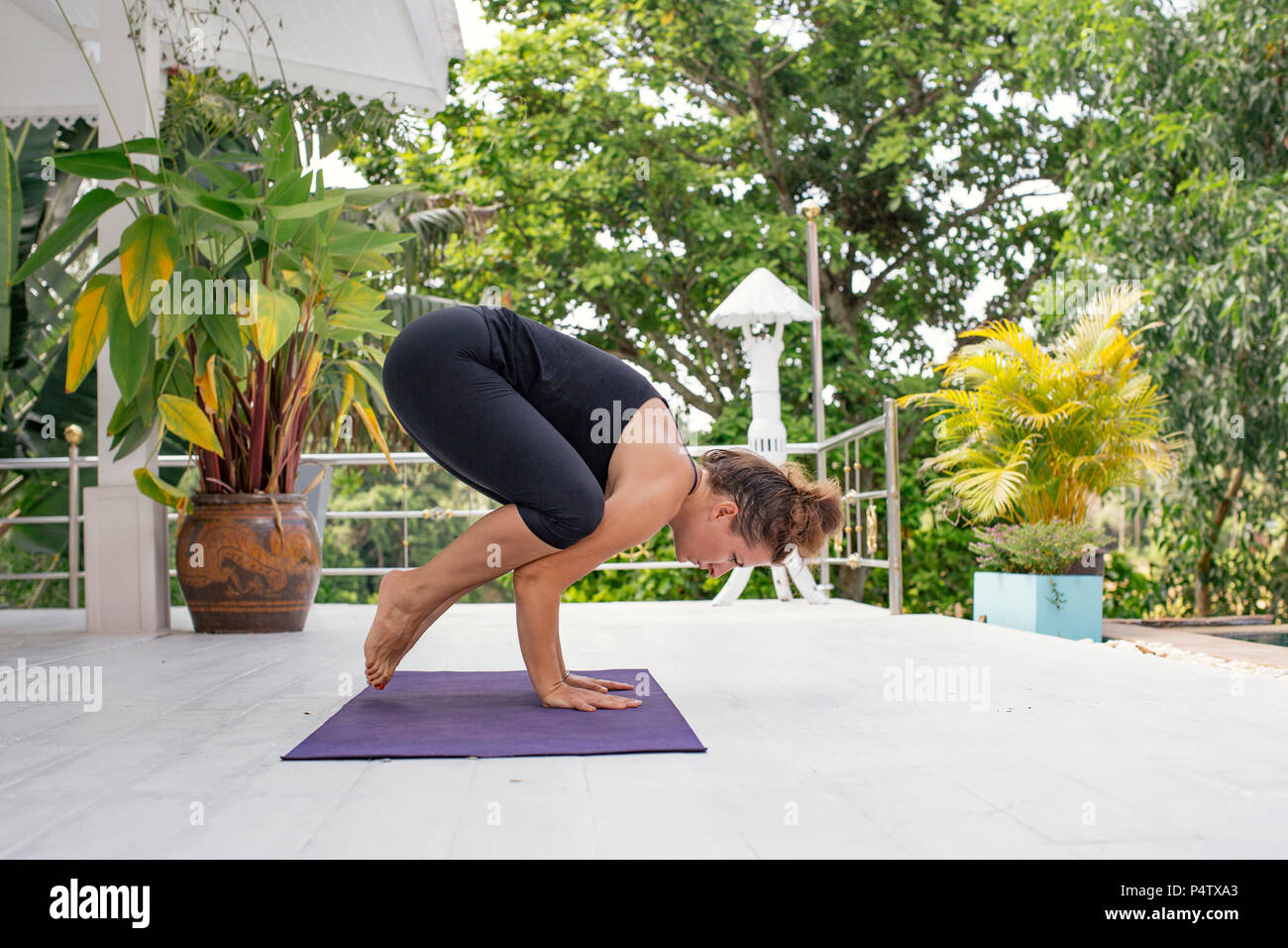 Woman practicing yoga on terrace Stock Photo - Alamy