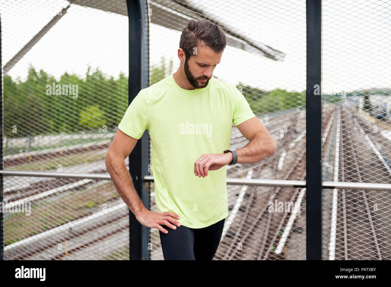 Man having a break from running checking the time on a smartwatch Stock ...