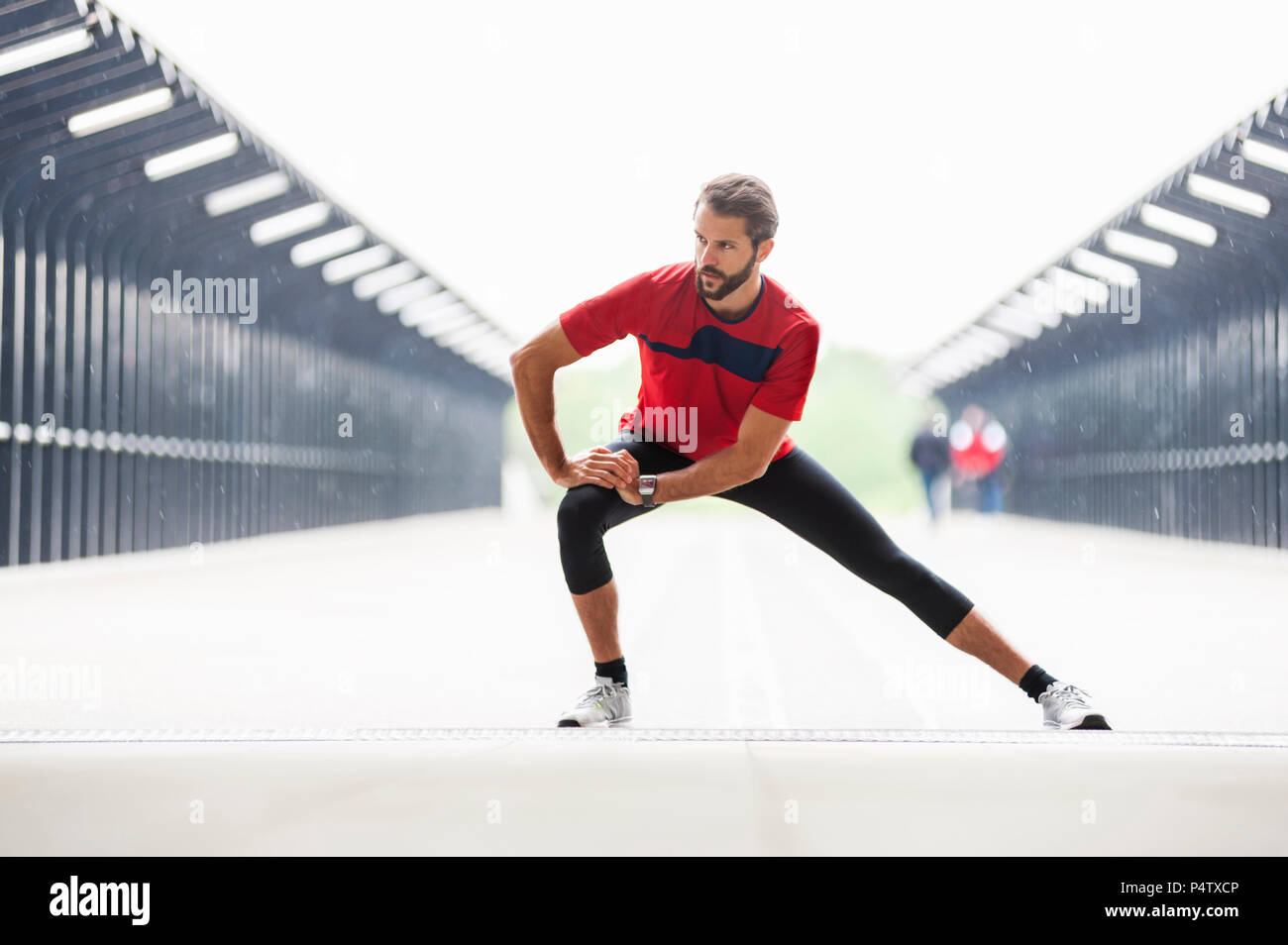 Man stetching on a bridge Stock Photo - Alamy