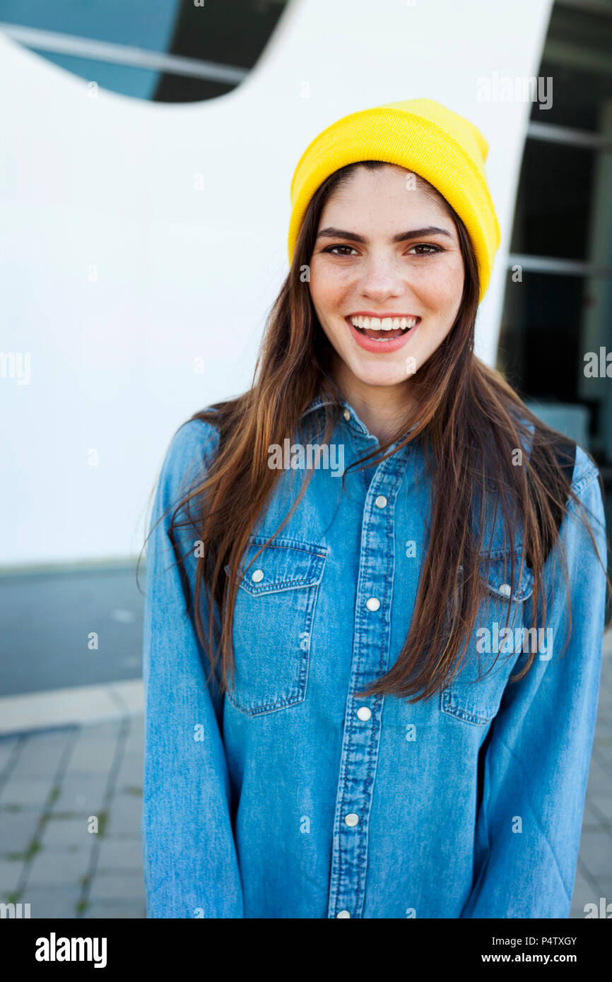 Portrait laughing young woman wearing yellow cap hi-res stock ...