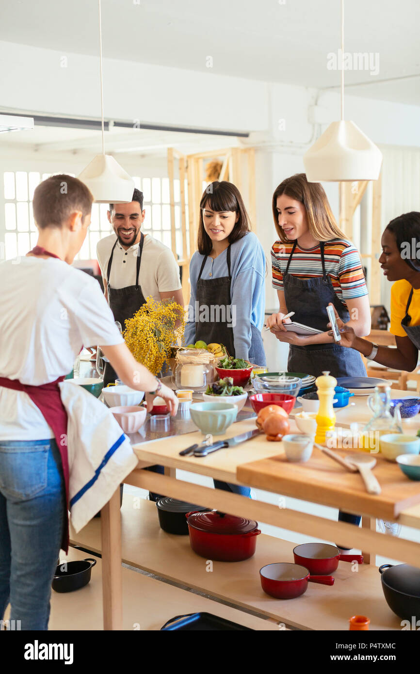 Friends in a cooking workshop watching instructor Stock Photo - Alamy