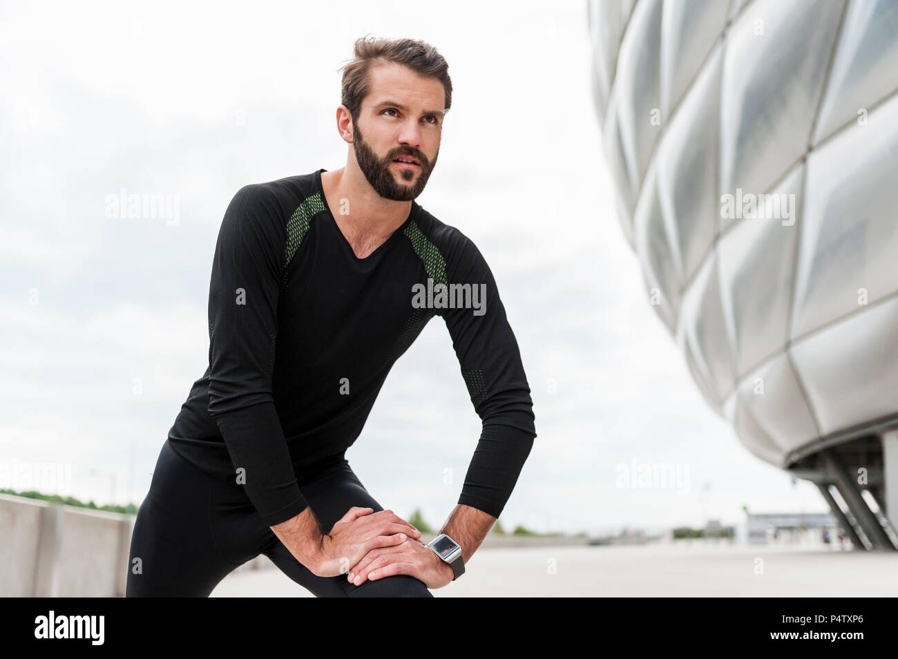 Man stetching at stadium Stock Photo - Alamy