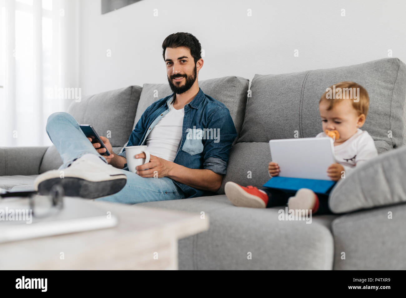 Father working in the living room while the daughter watching the ...