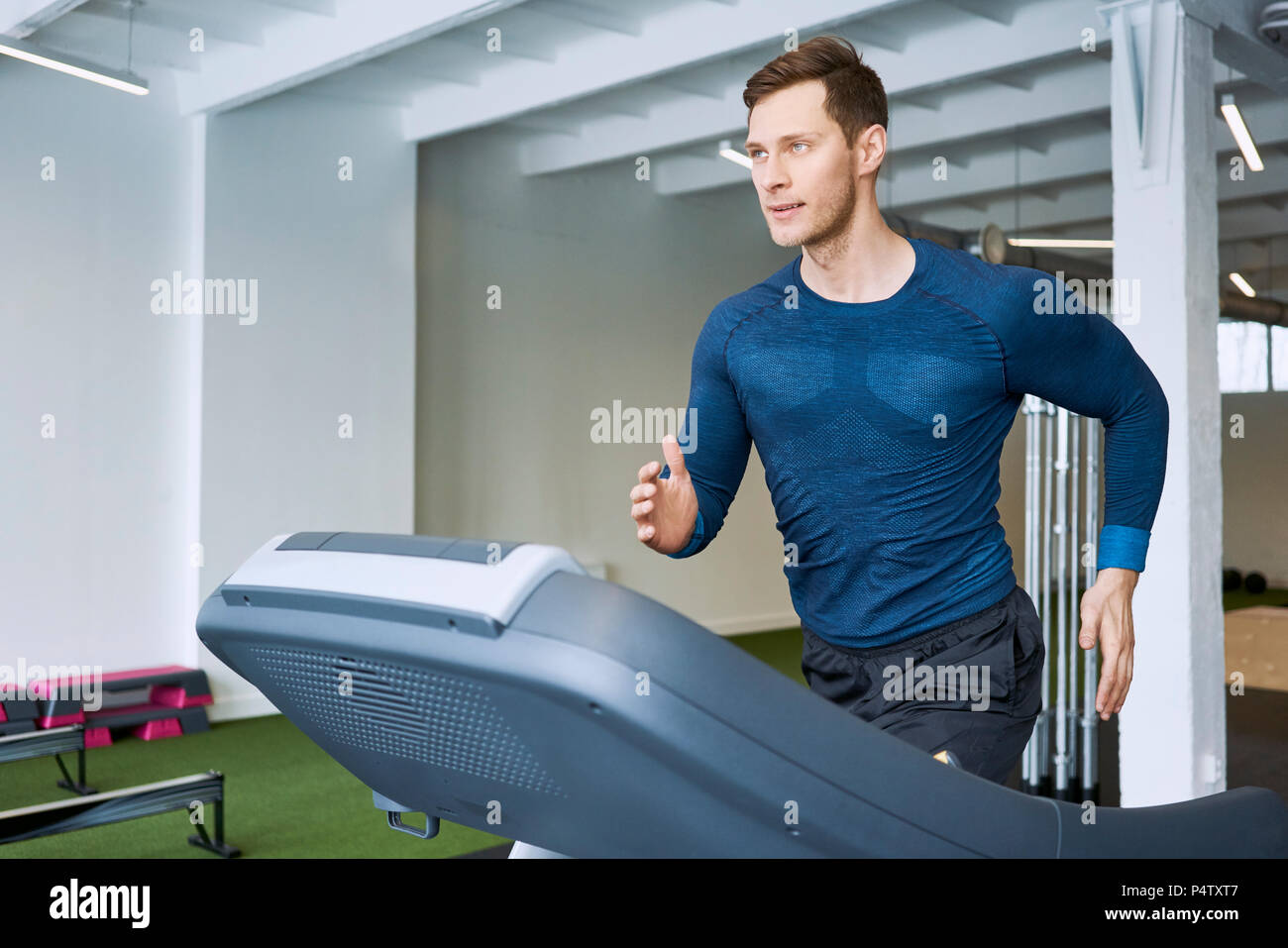 Man running on treadmill at gym Stock Photo - Alamy