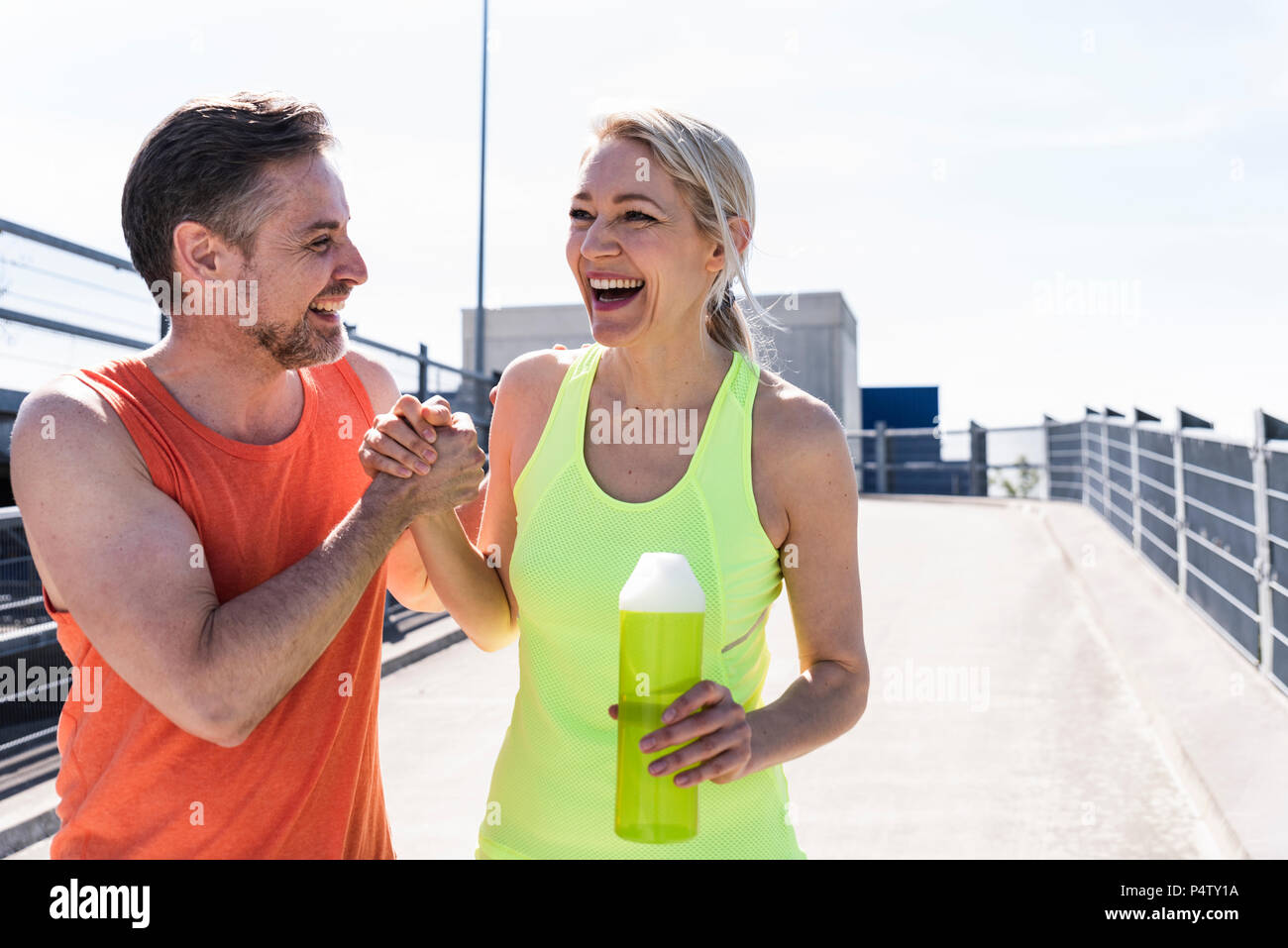 Fit couple jogging in the city, having fun, taking a break Stock Photo ...