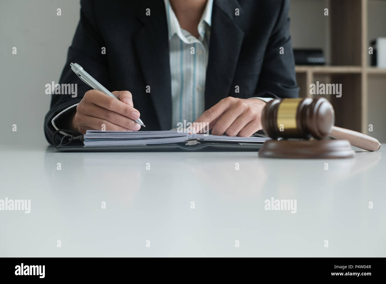 judge writing note with legal law gavel on desk. lawyer attorney ...