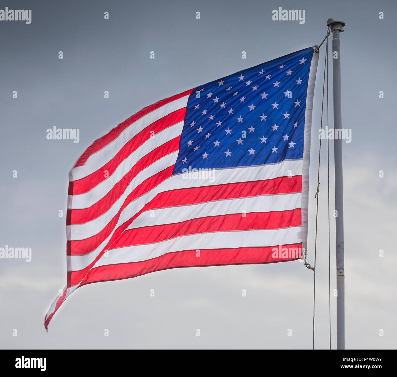 American flag brightly light with clouds behind with motion blur Stock ...