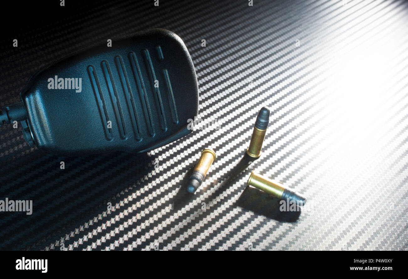Three rim fire bullets with a police type of microphone Stock Photo - Alamy