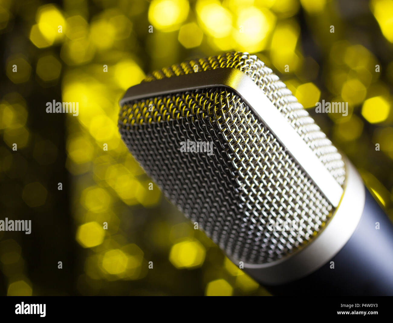 Mike with a mesh cover and blurry background in yellow Stock Photo - Alamy